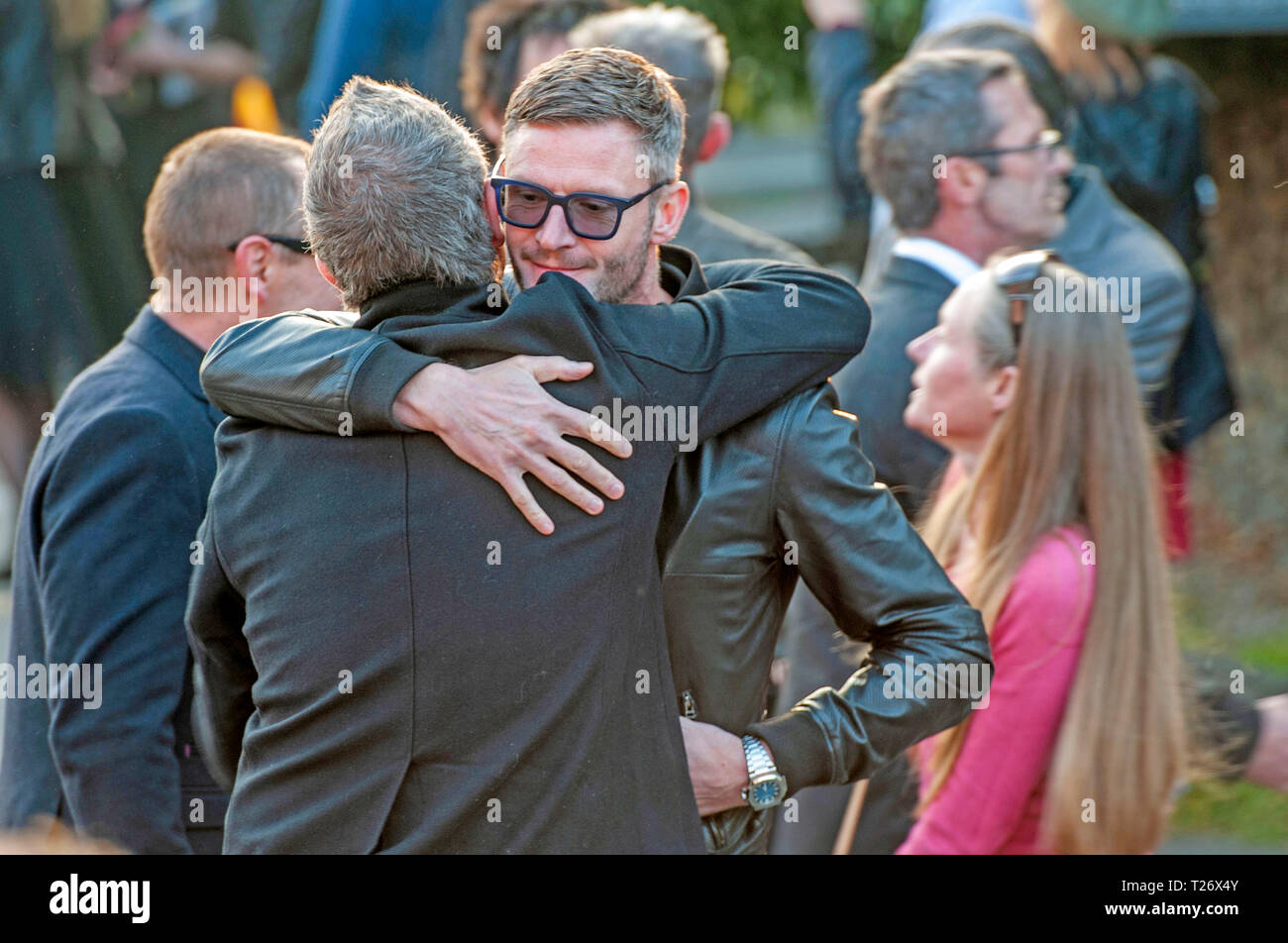 Essex, UK. 30th March 2019. Mourners comfort each other after leaving ...