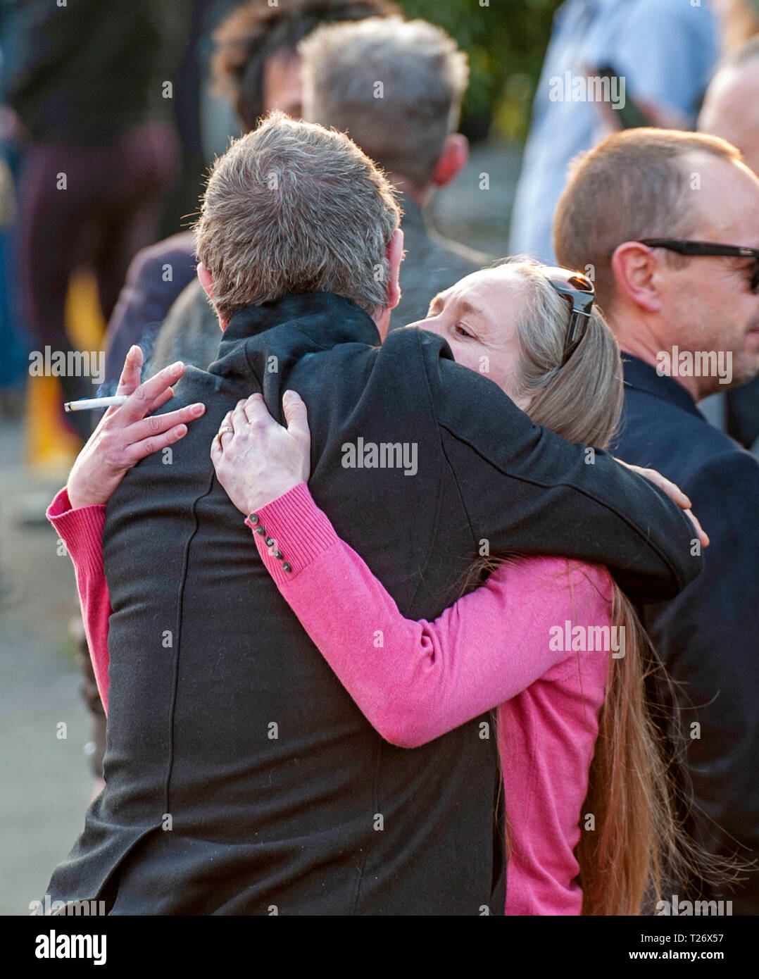 Essex, UK. 30th March 2019. Mourners comfort each other after leaving ...