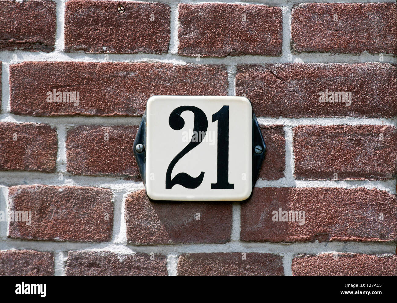 House number plate 21 screwed onto a brick wall Stock Photo - Alamy