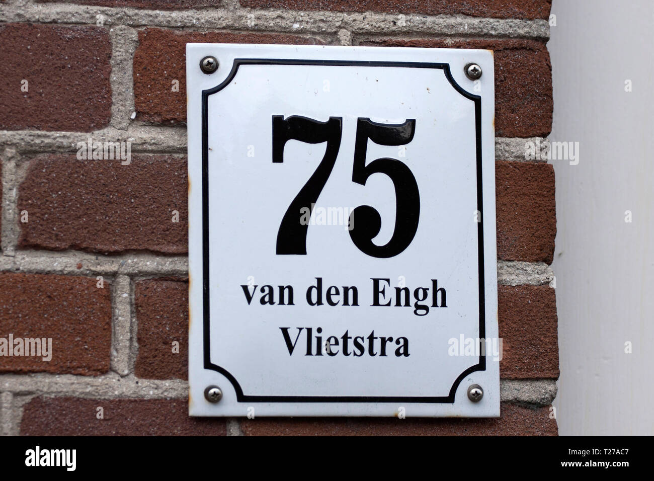 House number plate with name of the residents and number 75 Stock Photo ...