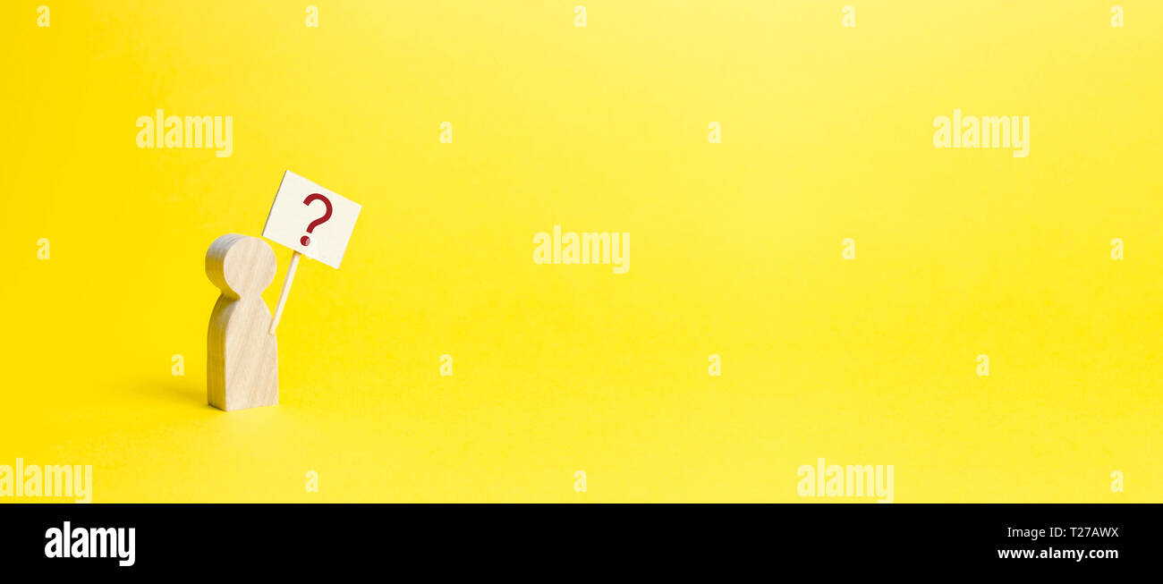 Wooden human figurine with a question mark. Minimalism. Asking a ...