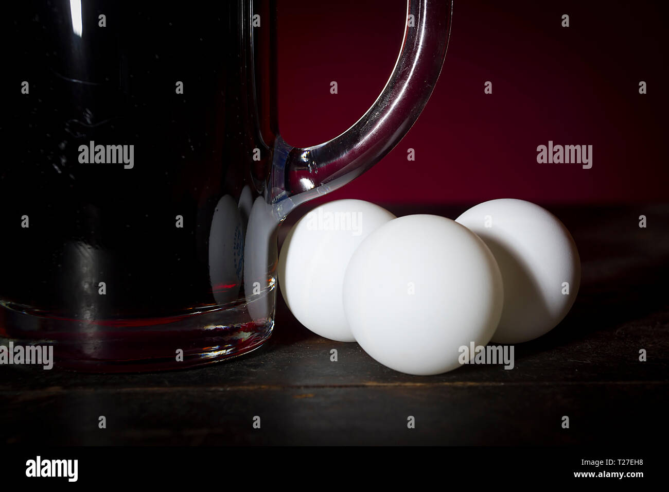 Glass with beer and balls for playing ping pong Stock Photo - Alamy