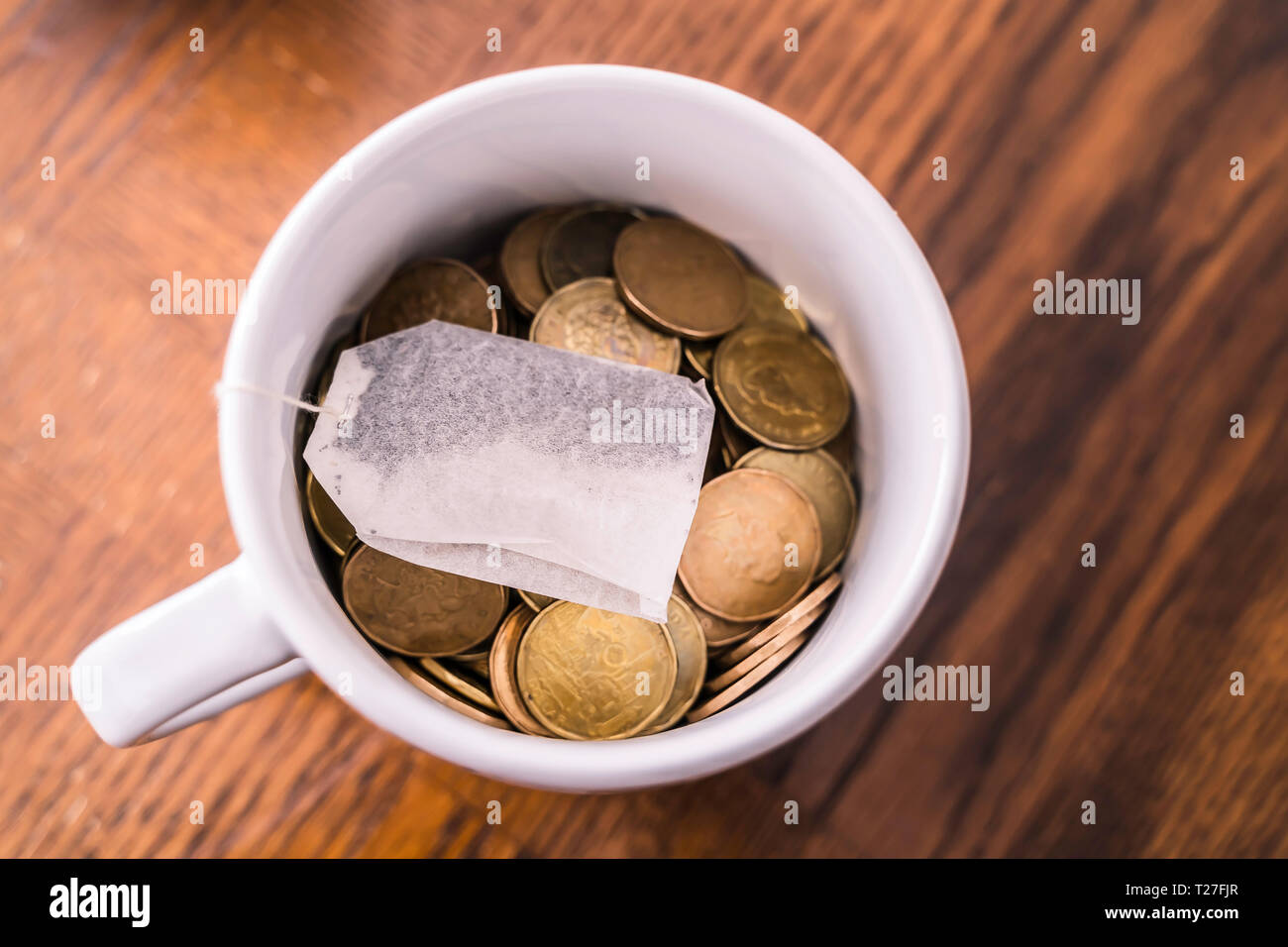 Coins in cup hi-res stock photography and images - Alamy