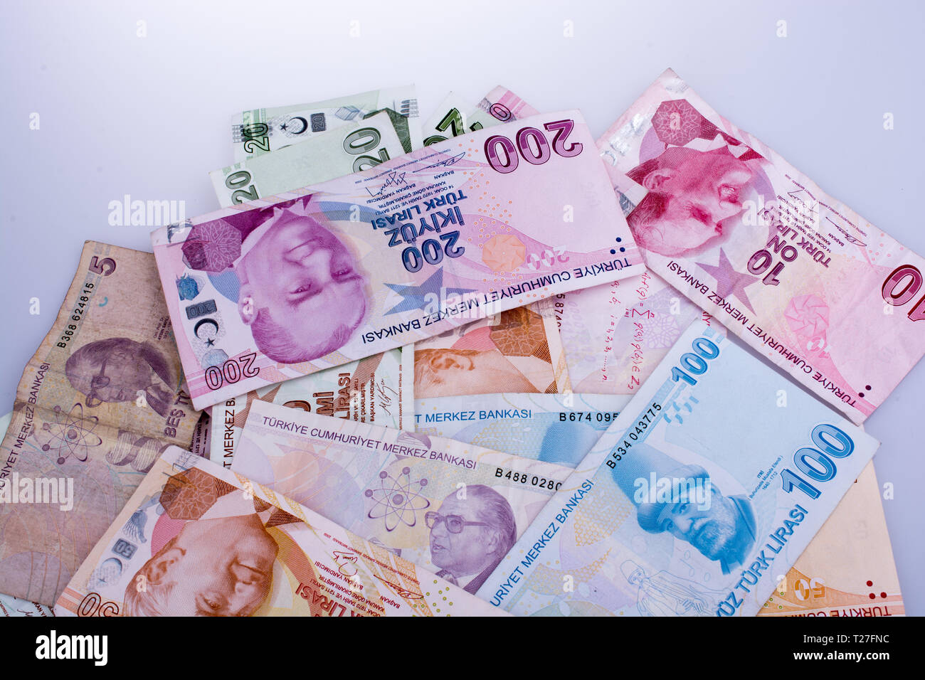 Turksh Lira banknotes of various color, pattern and value on white ...