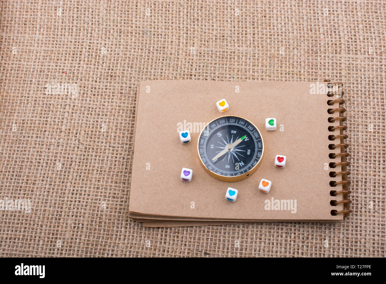 Heart cubes around a compass on canvas Stock Photo - Alamy