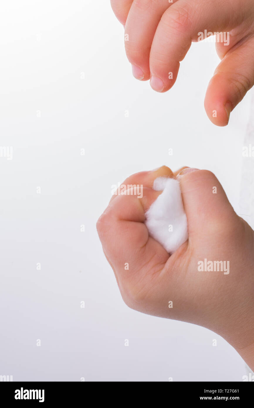 Hand holding some cotton in hand on a white background Stock Photo - Alamy