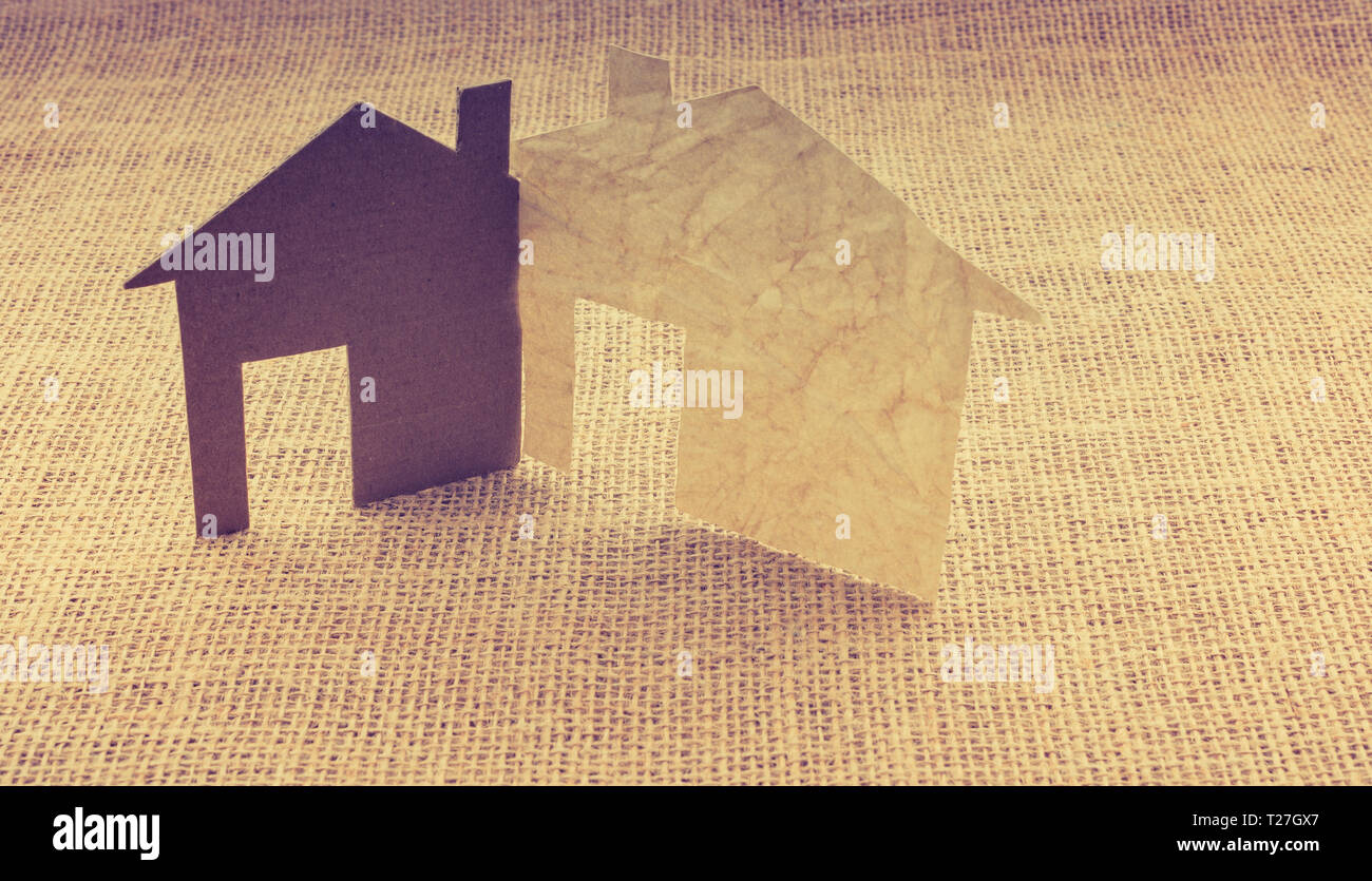 Little house shape cut out of paper on a canvas background Stock Photo ...