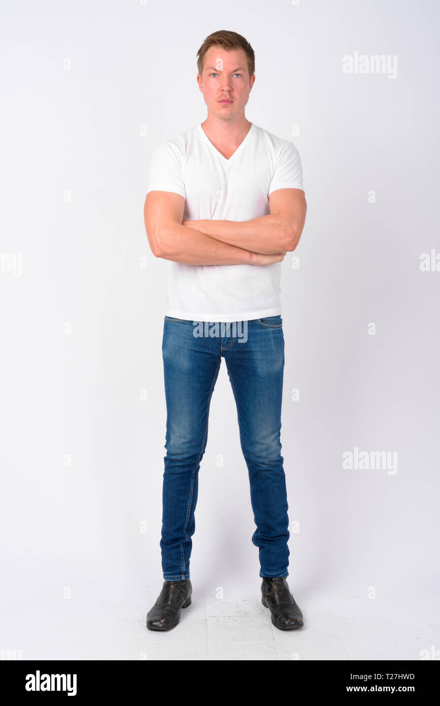 Full body shot of young handsome man with arms crossed Stock Photo - Alamy