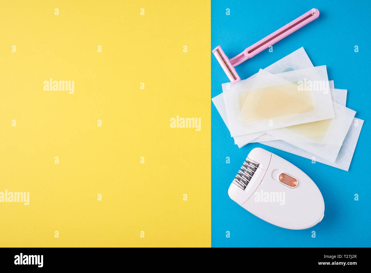 Epilator, razor for shaving and wax strips on blue and yellow ...