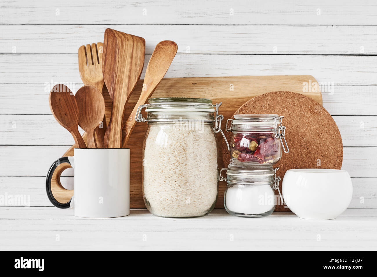 Kitchen tools and cutting board on white table, front view. Kitchen ...