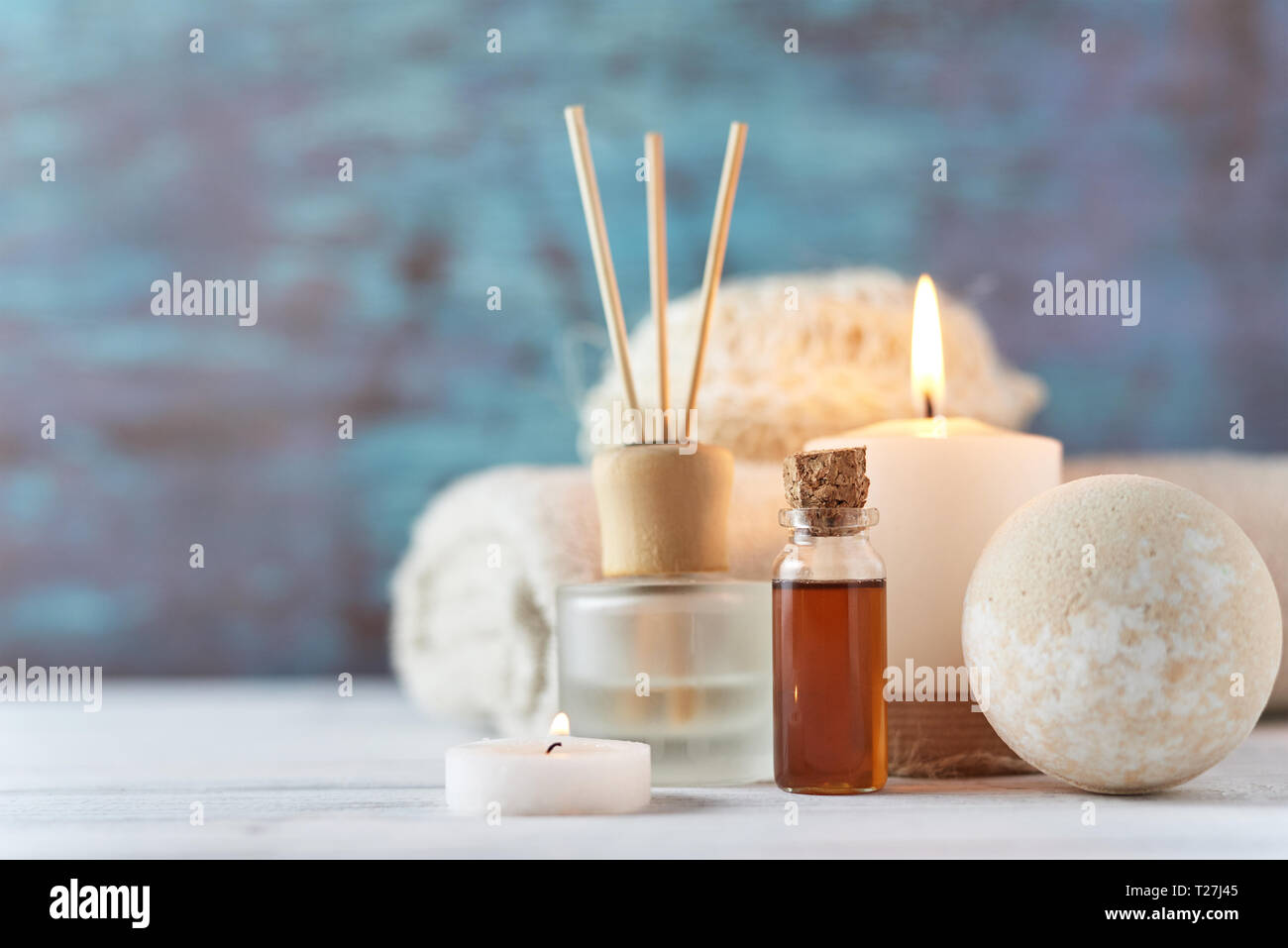 Spa and relax composition with massage oil, towels and burning candle ...