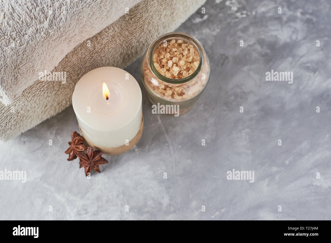 Spa and relax composition with massage oil, towels and burning candle ...