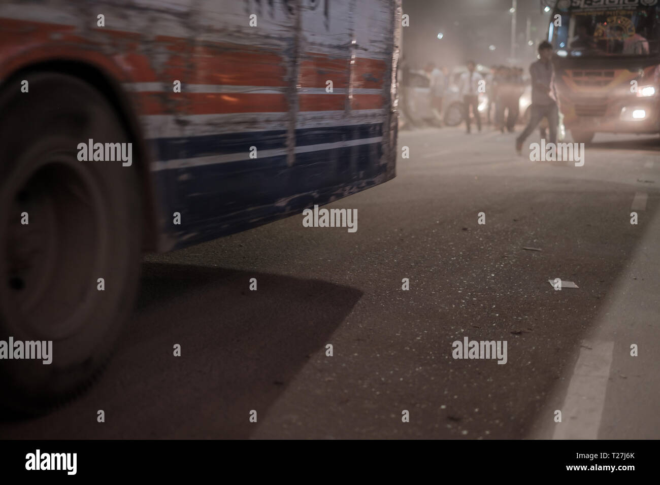 Peeling paint on the bus, polluted air, smog at night on streets of ...