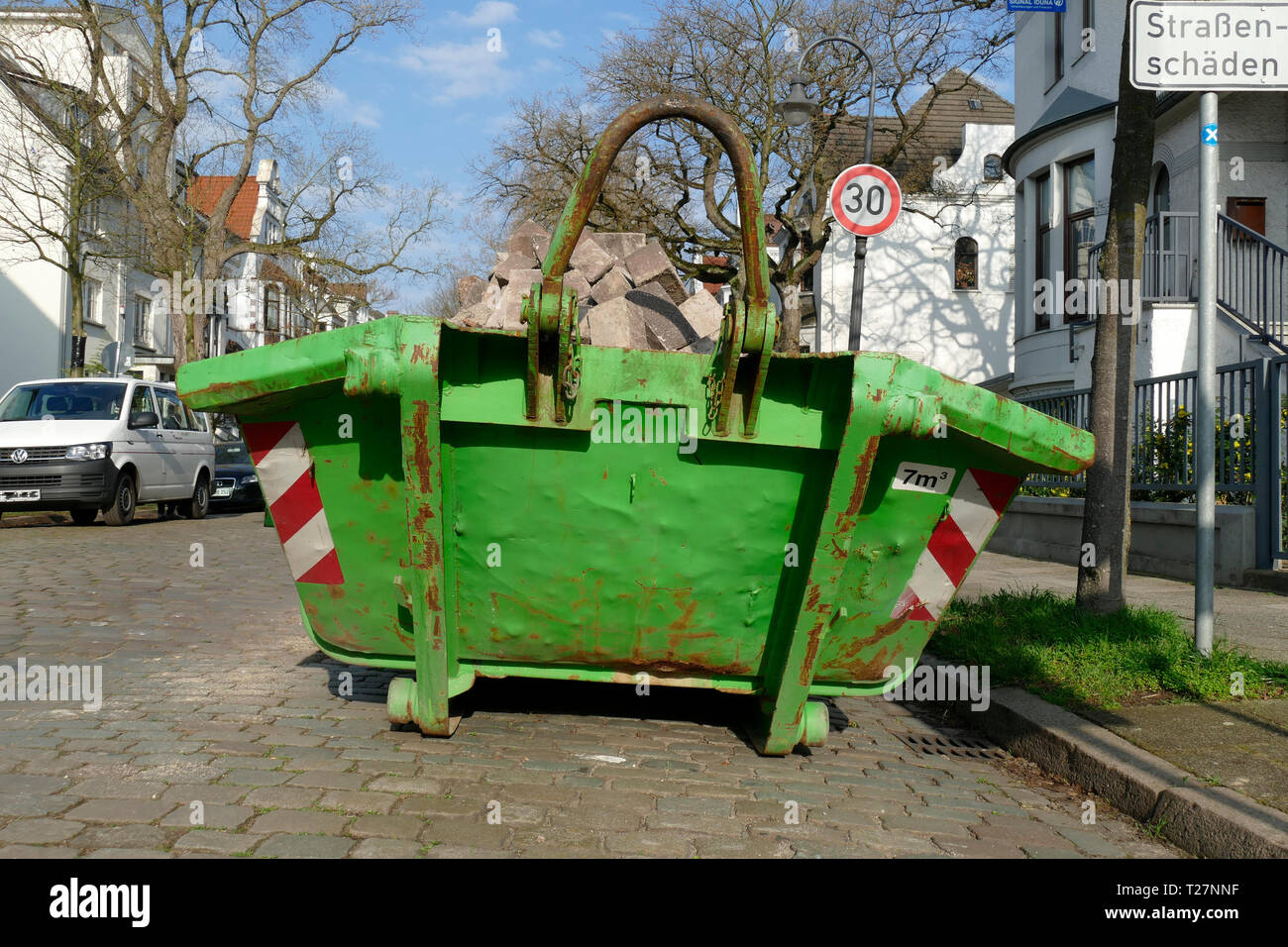 Old green sedimentation trough filled with rubble in a residential ...