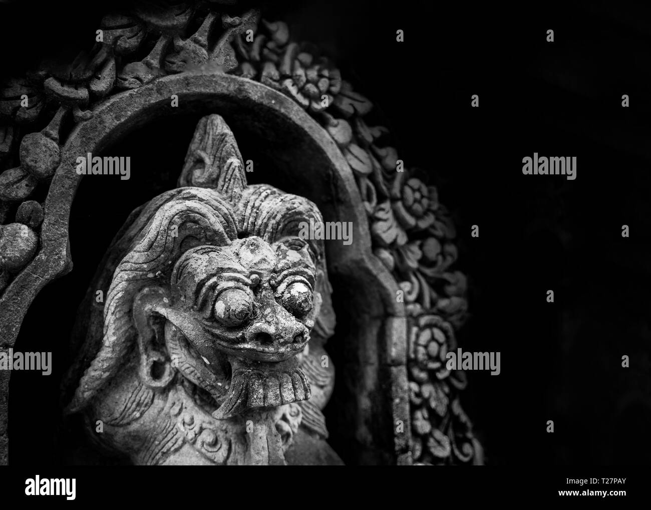 Traditional balinese demon statue isolated on black background with ...
