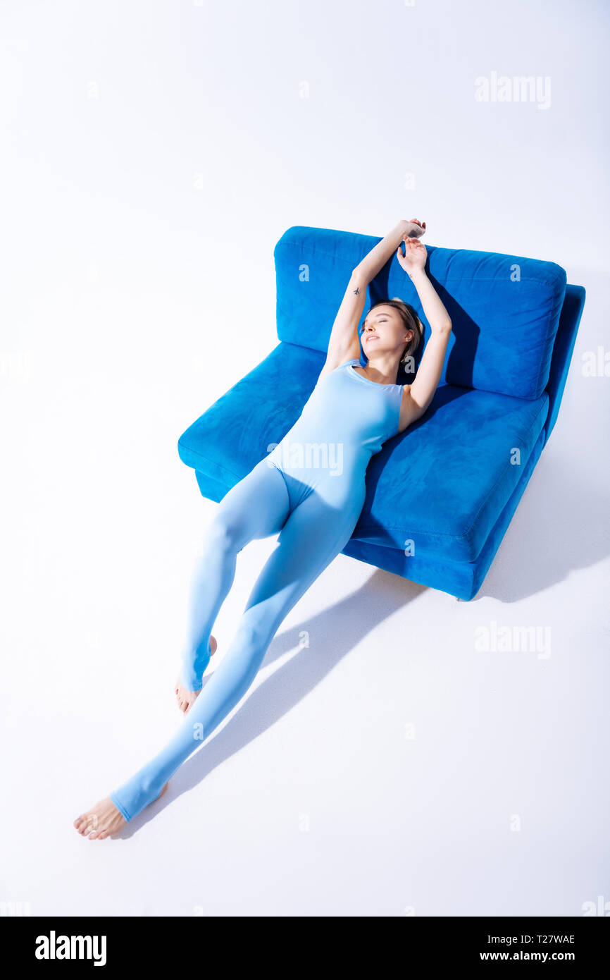 Positive fit woman relaxing on the sofa Stock Photo - Alamy