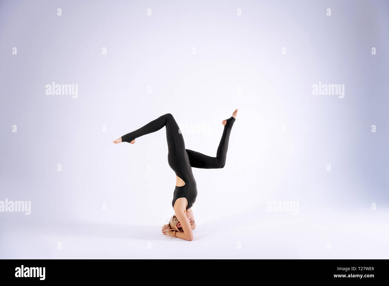 Skilled fit female acrobat having her training Stock Photo - Alamy