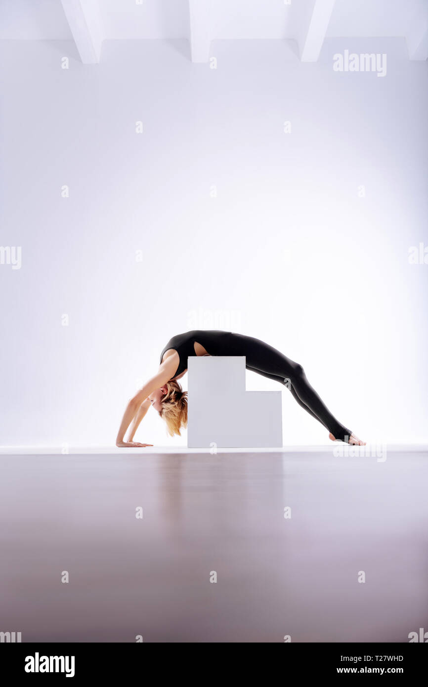 Good looking slim young woman leaning backwards Stock Photo - Alamy