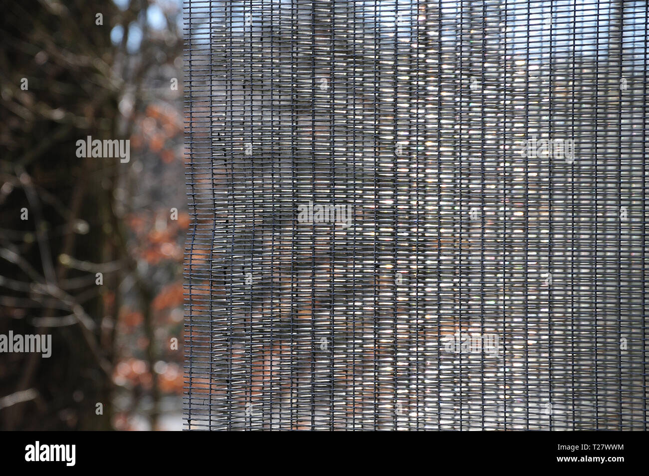 protection grid of stainless steel at a facade reflecting sunlight ...