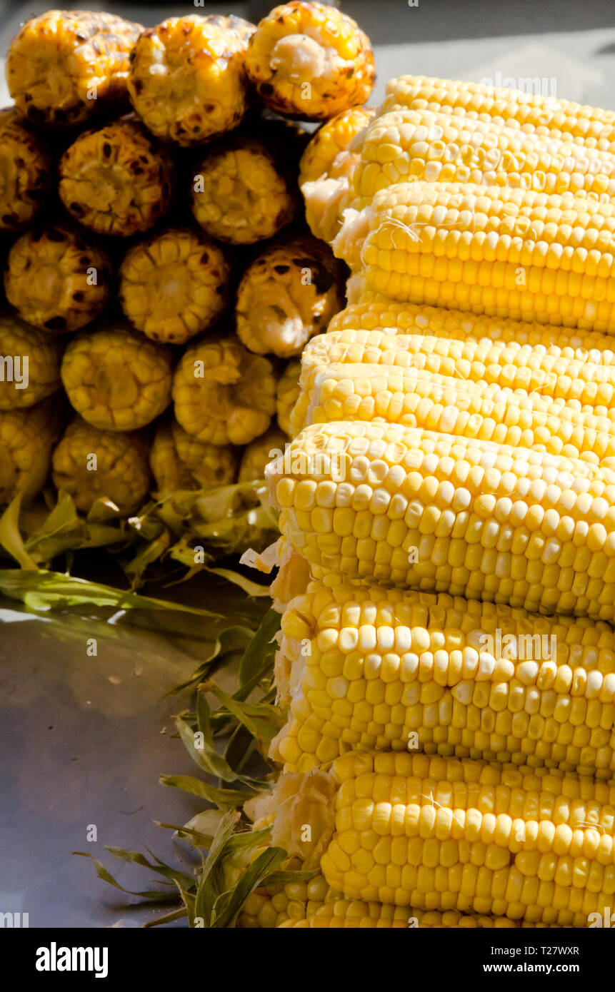 extreme close up of grilled and boiled corn on street sale on sunny day ...