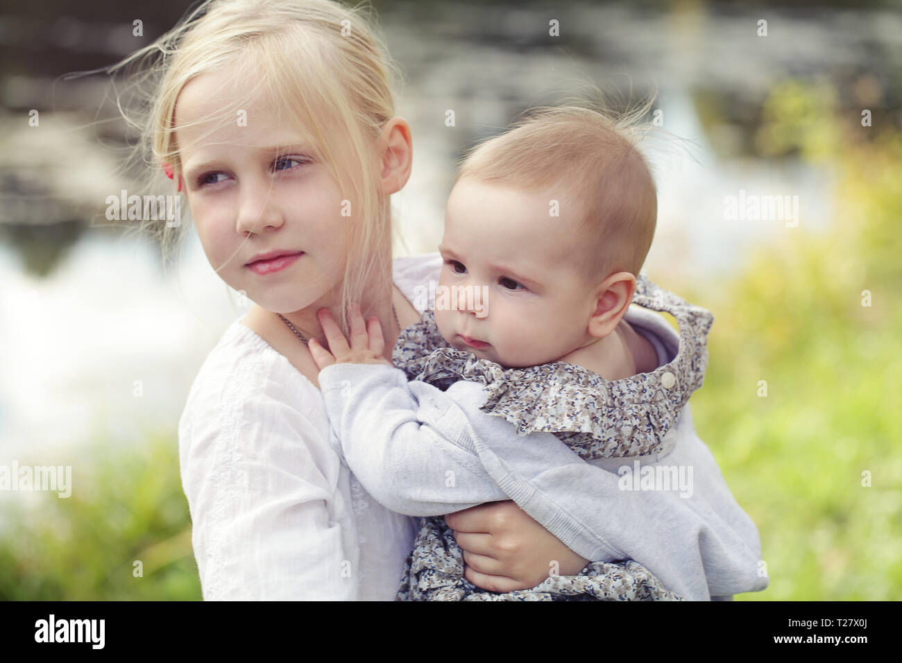 Two cute little sisters kissing hi-res stock photography and images - Alamy