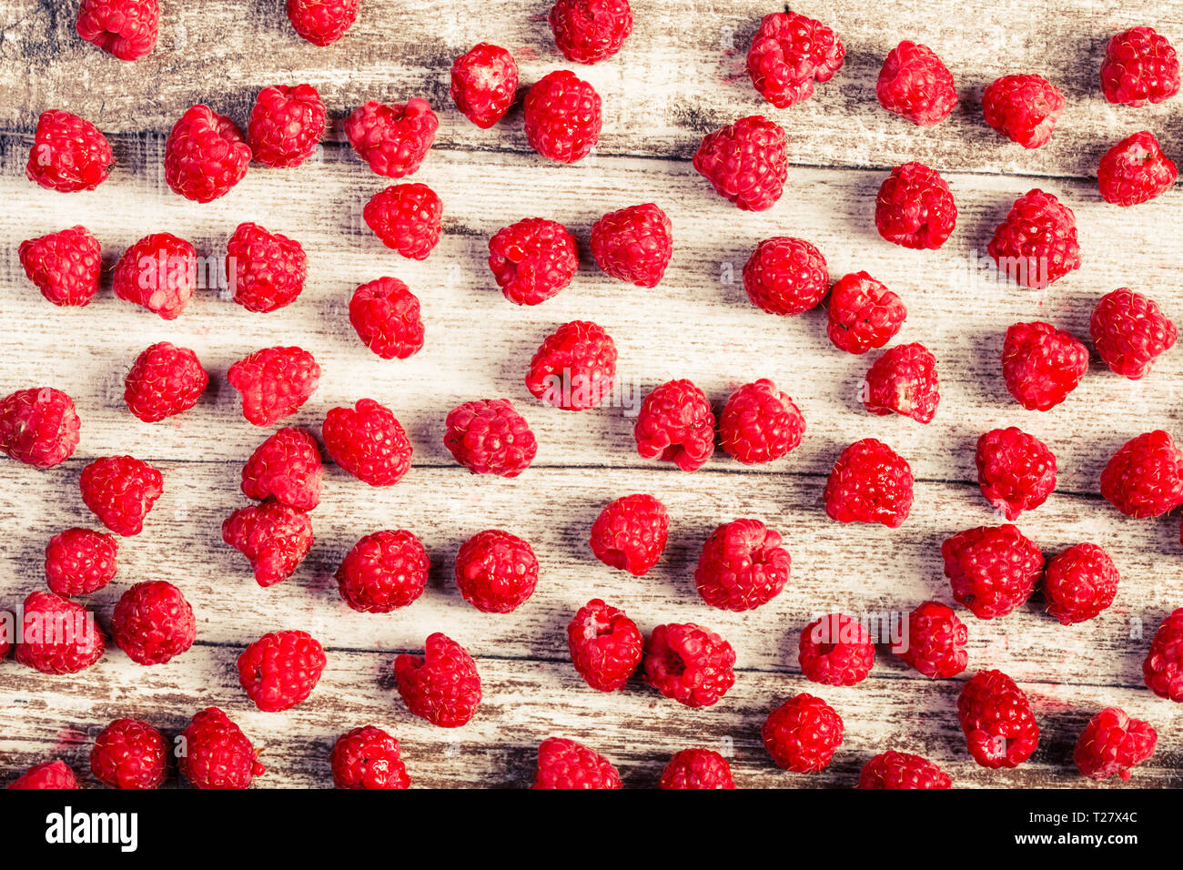 Spred of fresh raspberry on wooden table. Summer fruits Stock Photo - Alamy