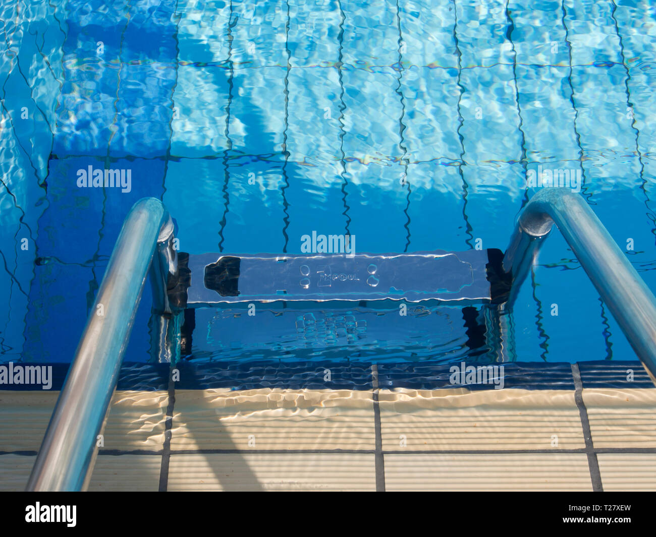 Entering a heated outdoors swimming pool in a comfortable hotel is are ...