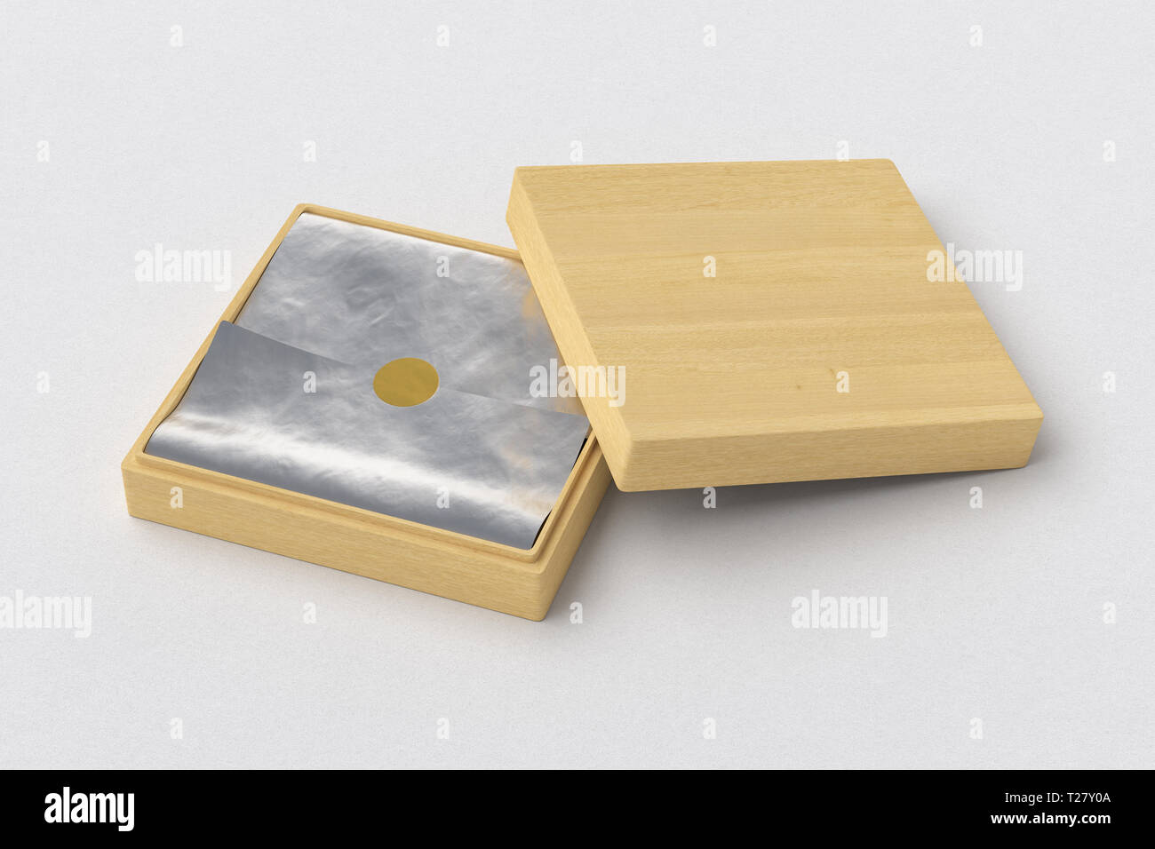Flat wooden square box with silver wrapping paper on white background ...