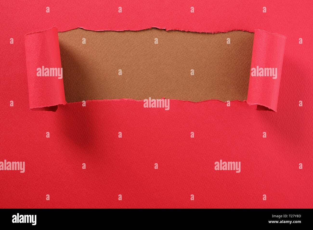 Torn red paper strip curled top edge revealing brown background Stock ...