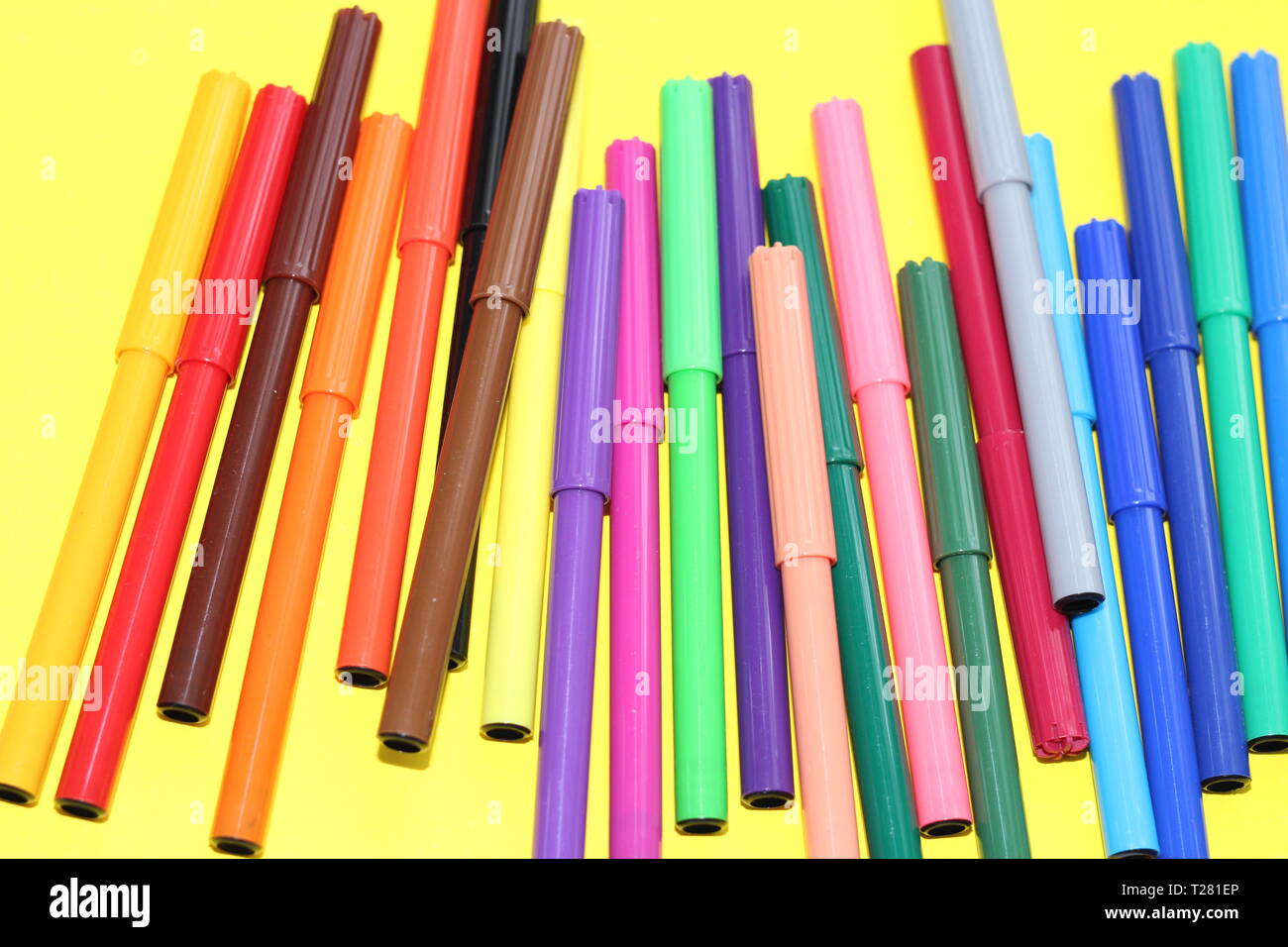 Markers are scattered on the table. Multi-color markers for drawing ...