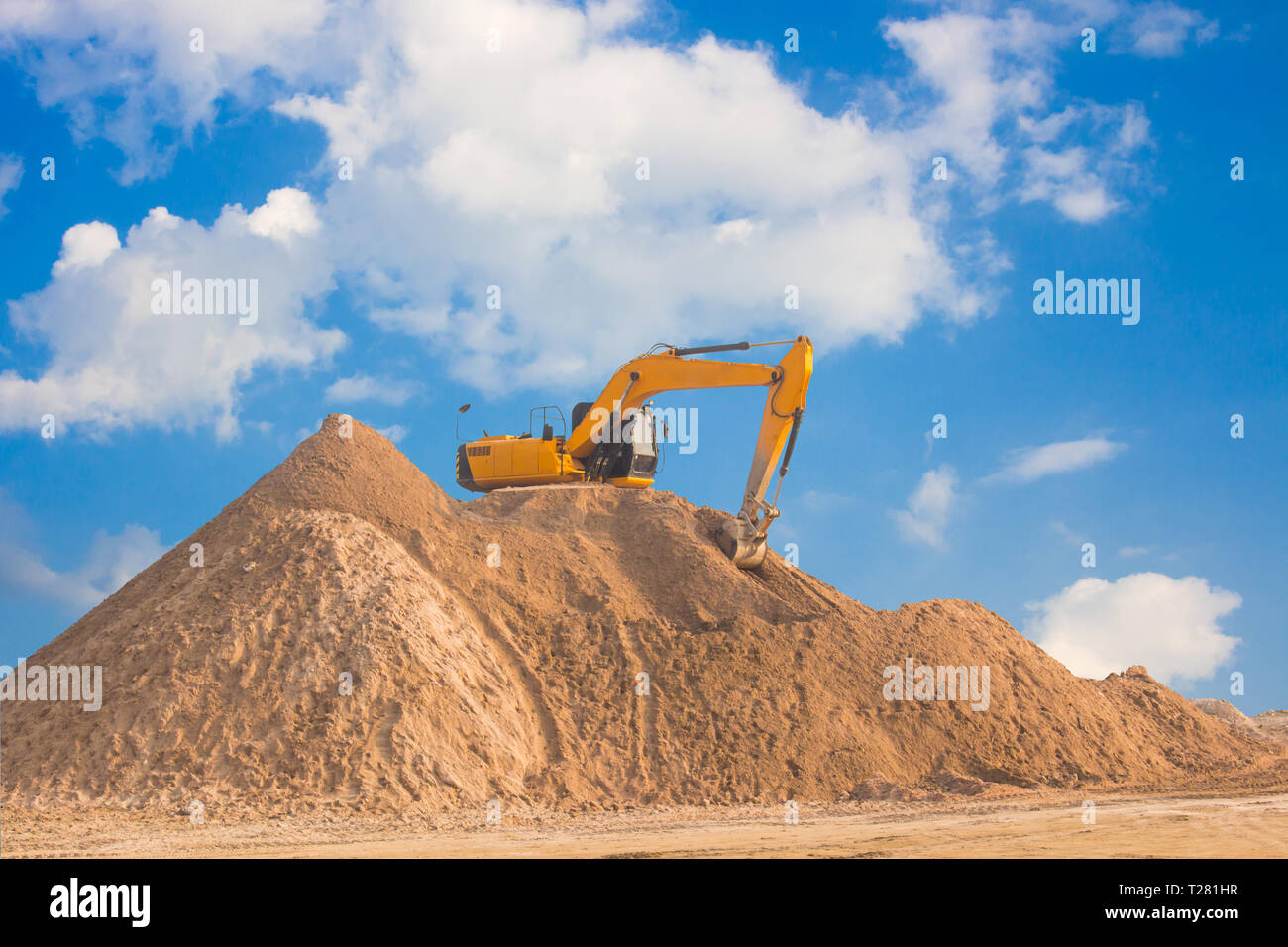 Excavators work on soil piles for construction Stock Photo - Alamy