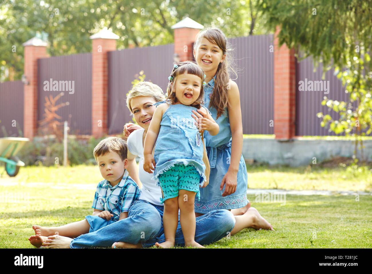 happy playful family outdoors. mom with children in the summer. Mother ...