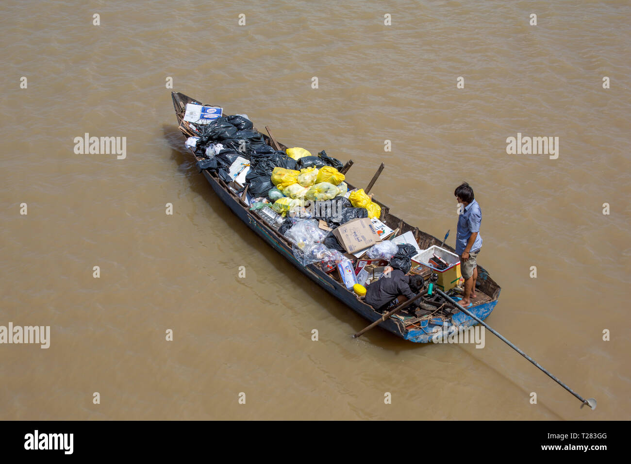 A boat filled with garbage on the Mekong River, Phonm Penh Cambodia ...