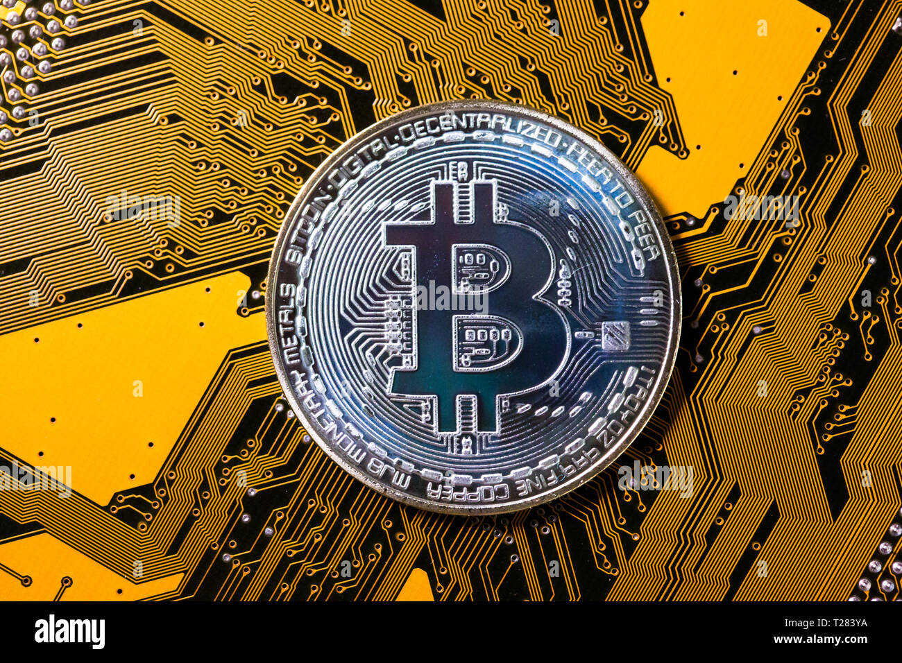 Mining Bitcoin concept - silver coin on a PCB Stock Photo - Alamy