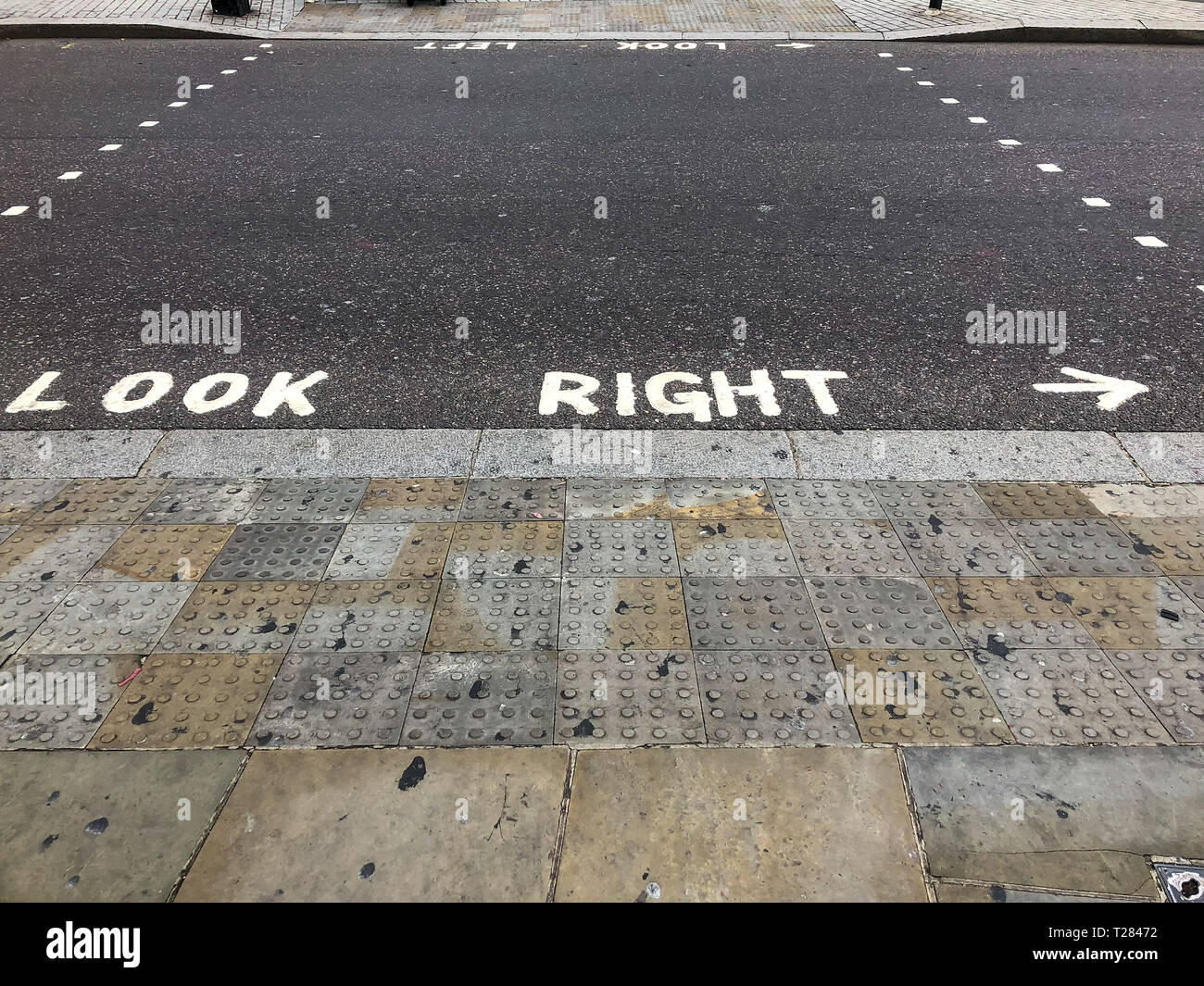 Look right warning painted on a pedestrian crossing in London, England ...
