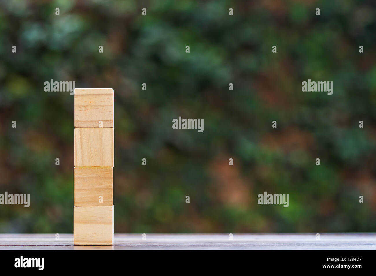 Stacked empty four wooden block on wood table with green nature ...