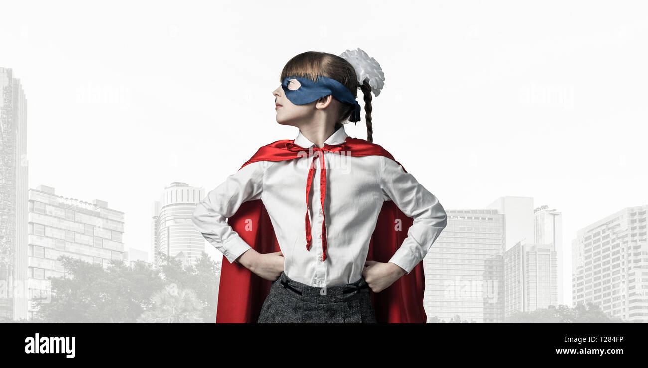Girl power concept with cute kid guardian against cityscape background ...