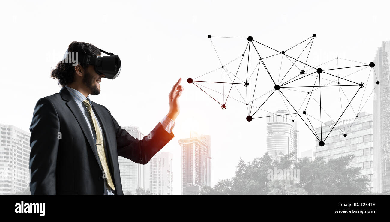 Handsome businessman experiencing impressive virtual reality connection ...
