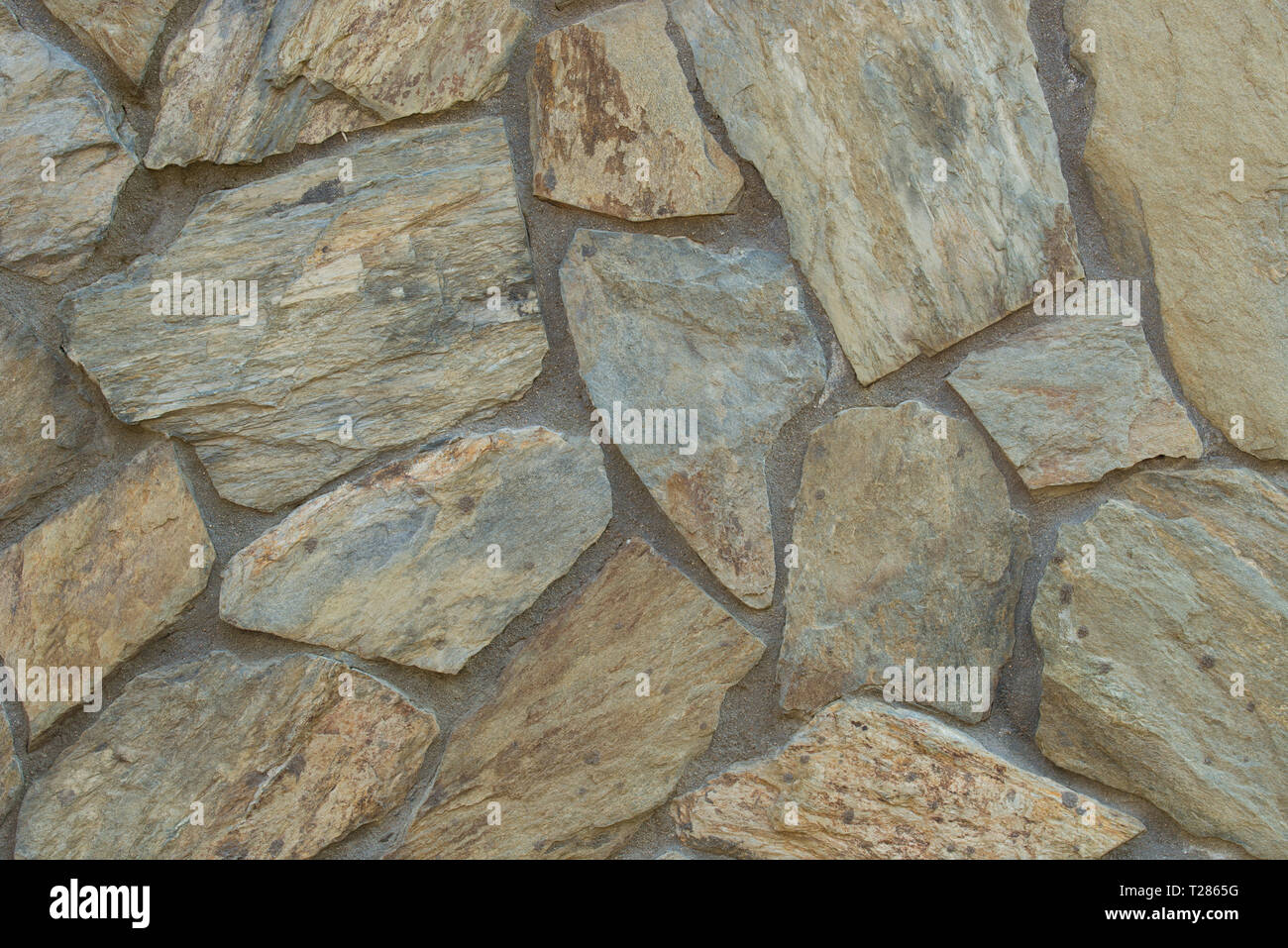 irregular stone wall background texture Stock Photo - Alamy