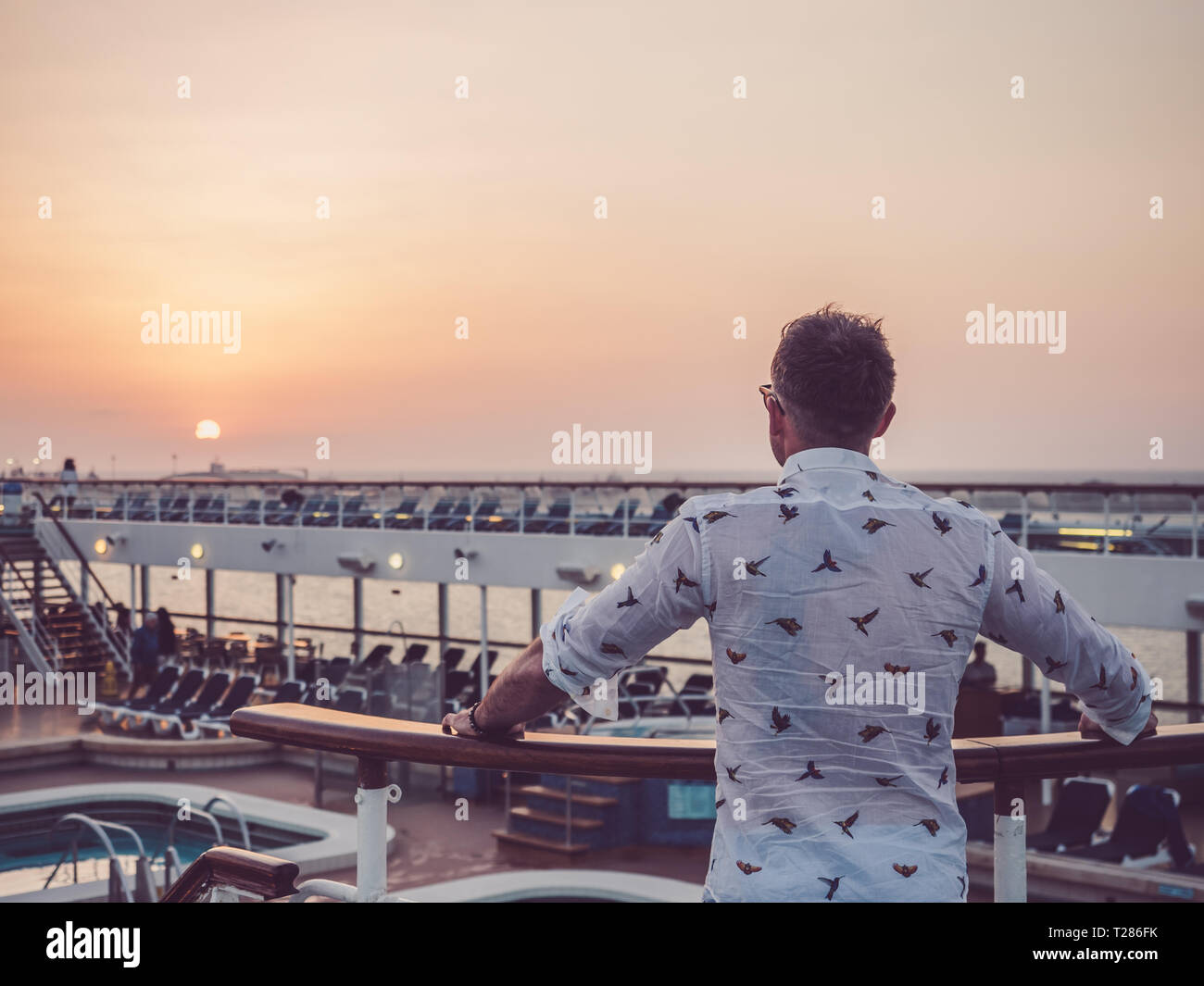 Attractive man standing on the empty deck Stock Photo - Alamy