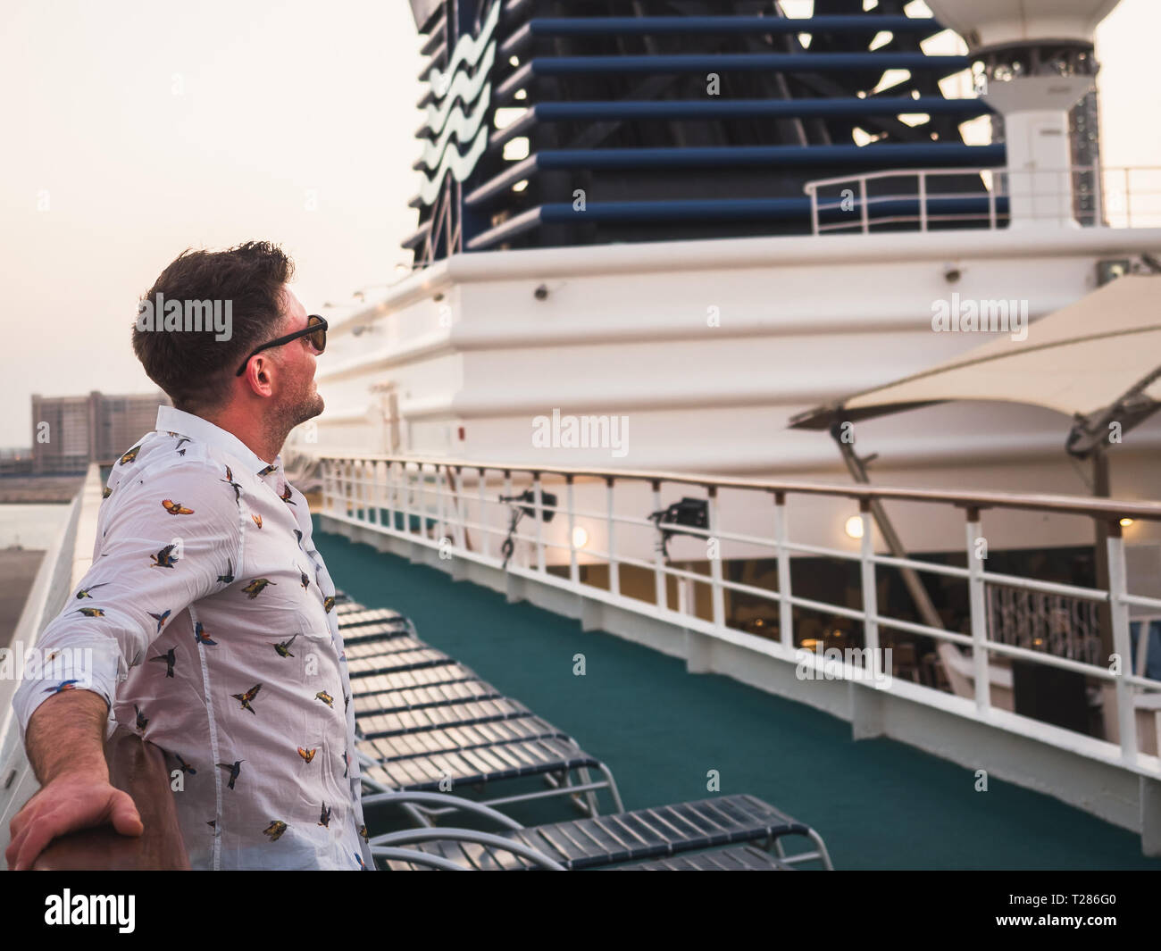 Attractive man standing on the empty deck Stock Photo - Alamy