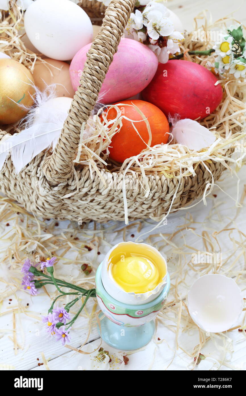 Easter still life with painted eggs and flowers on a white background ...