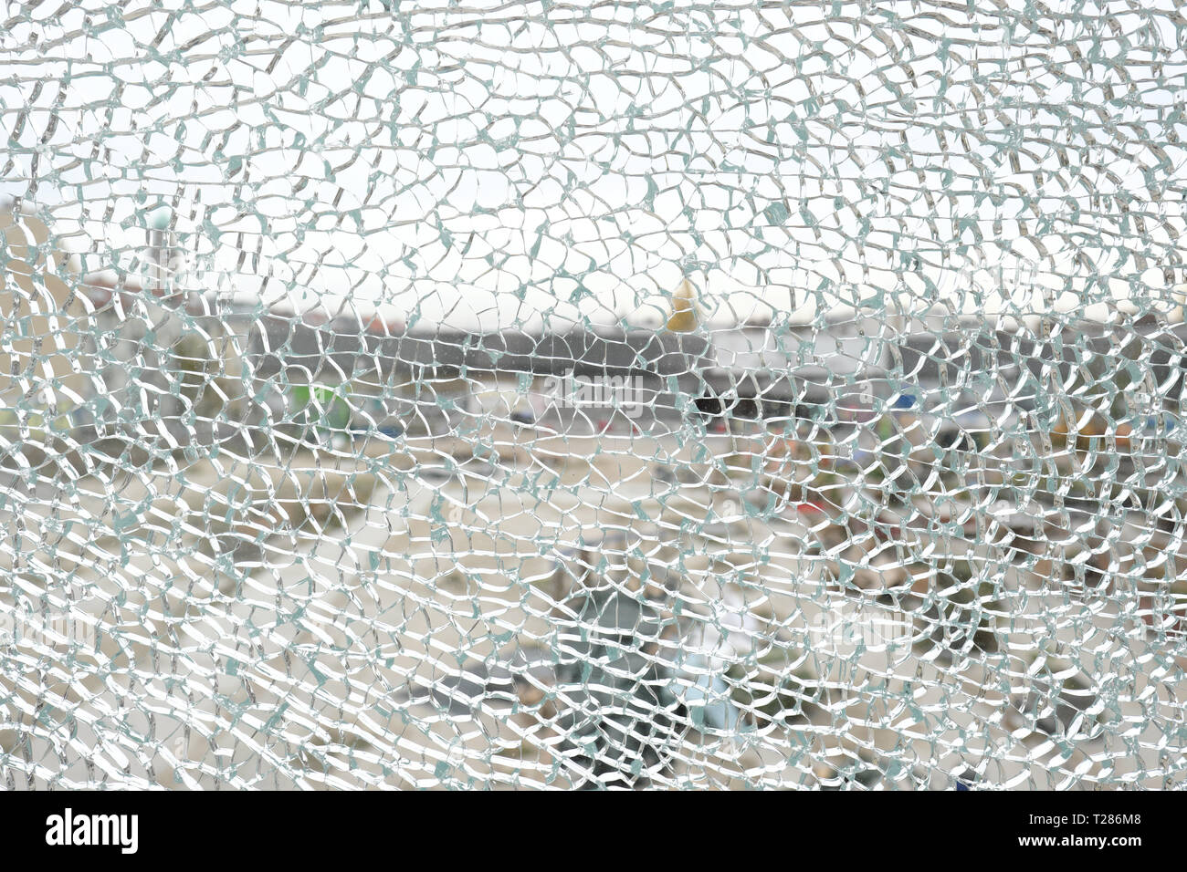 Broken smashed window pane in urban location Stock Photo - Alamy