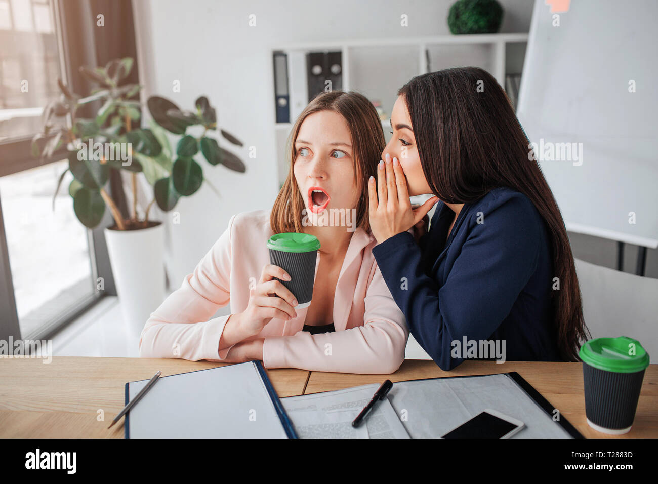 Two women gossip office hi-res stock photography and images - Alamy