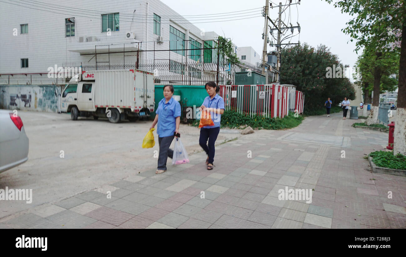 Shenzhen, China: Female workers walk on the streets after work Stock ...