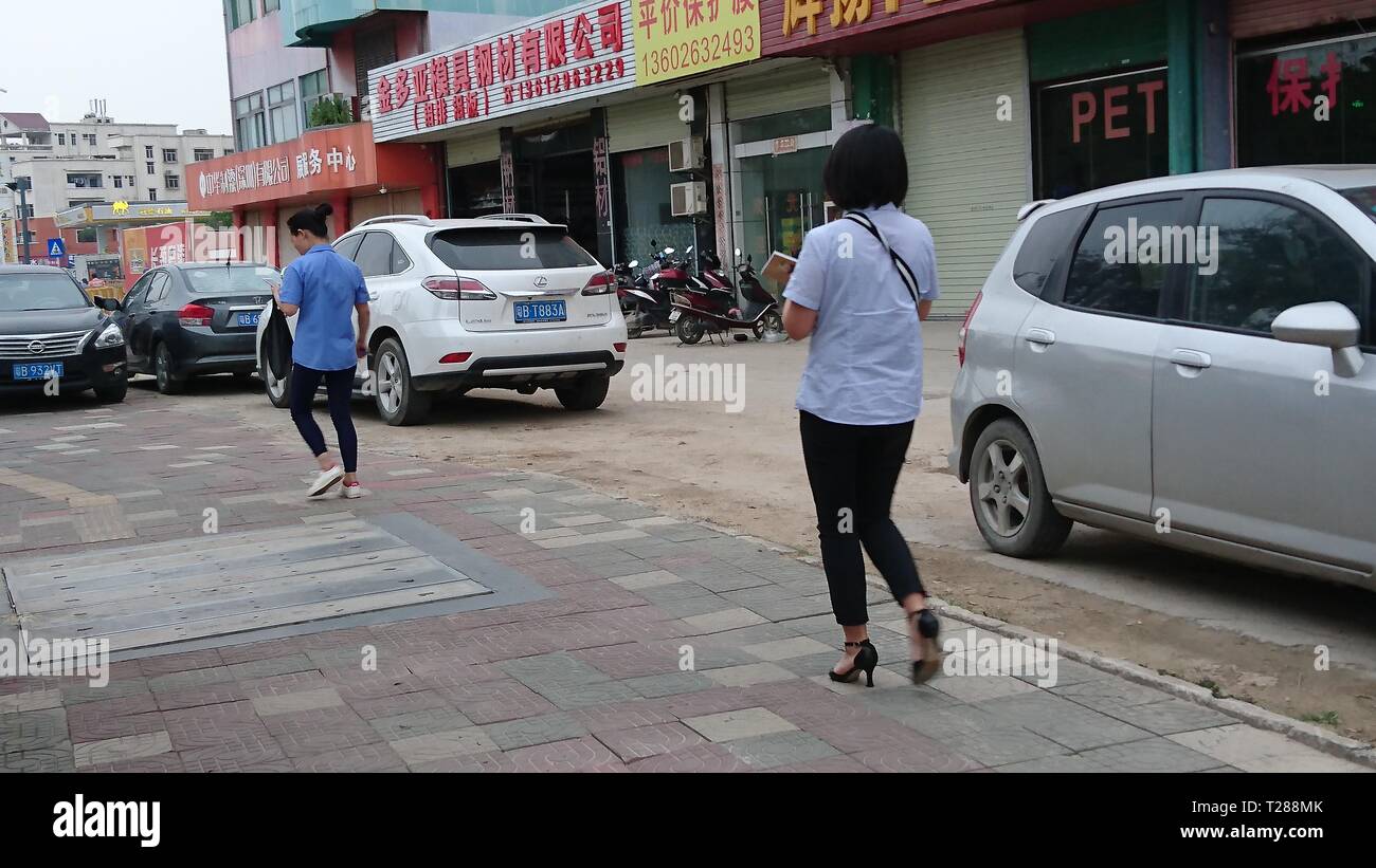 Shenzhen, China: Female workers walk on the streets after work Stock ...
