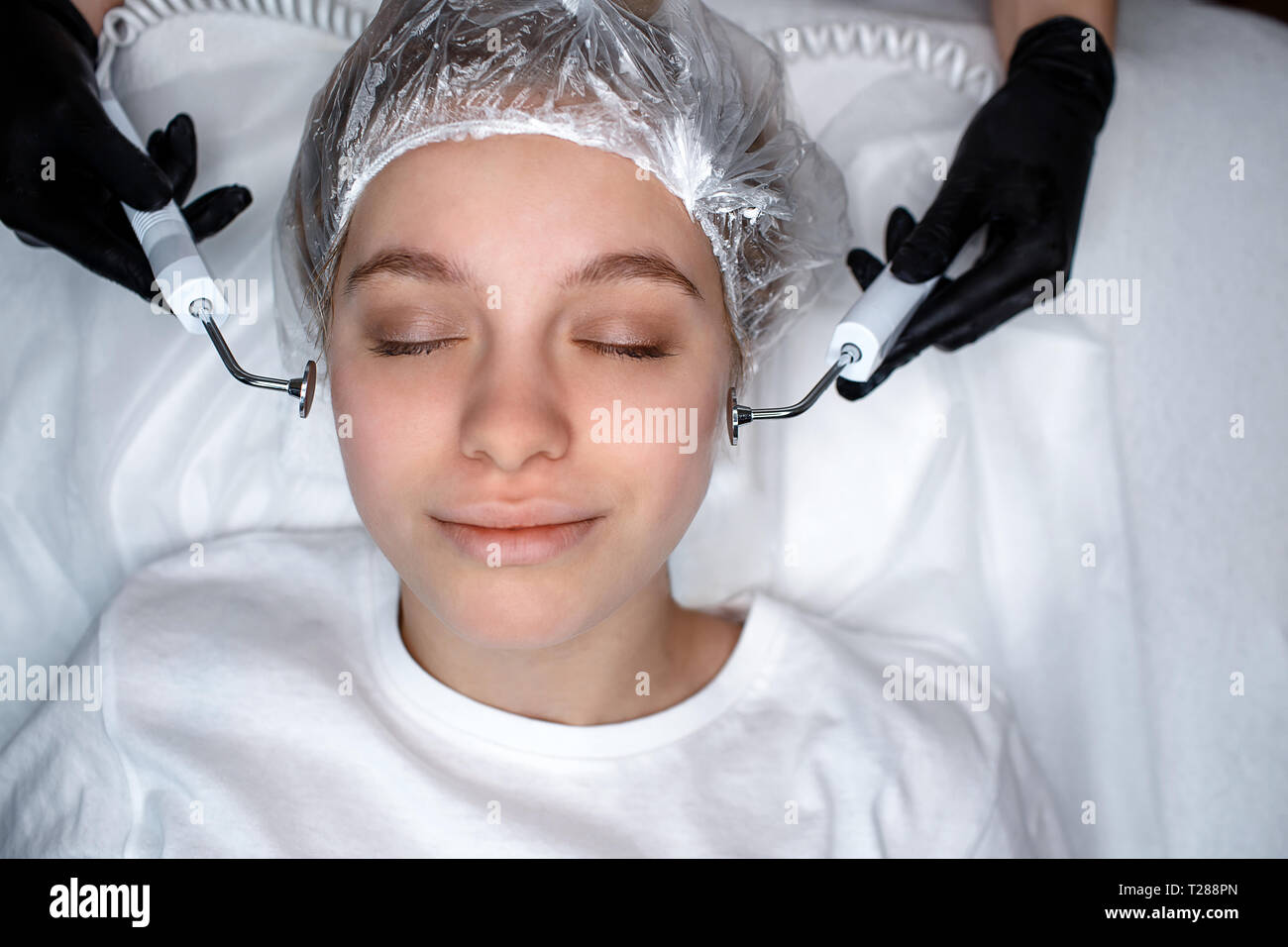 Relaxed peaceful young woman lying on couch with closed eyes. She enjoy ...