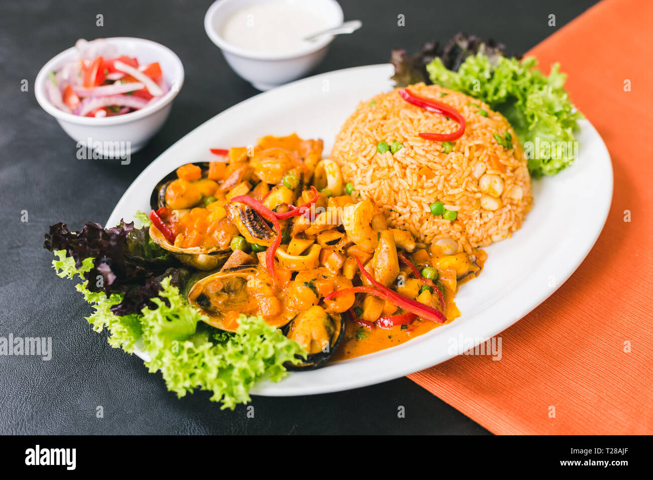 rice with seafood, peruvian sauce and garlic sauce Stock Photo - Alamy