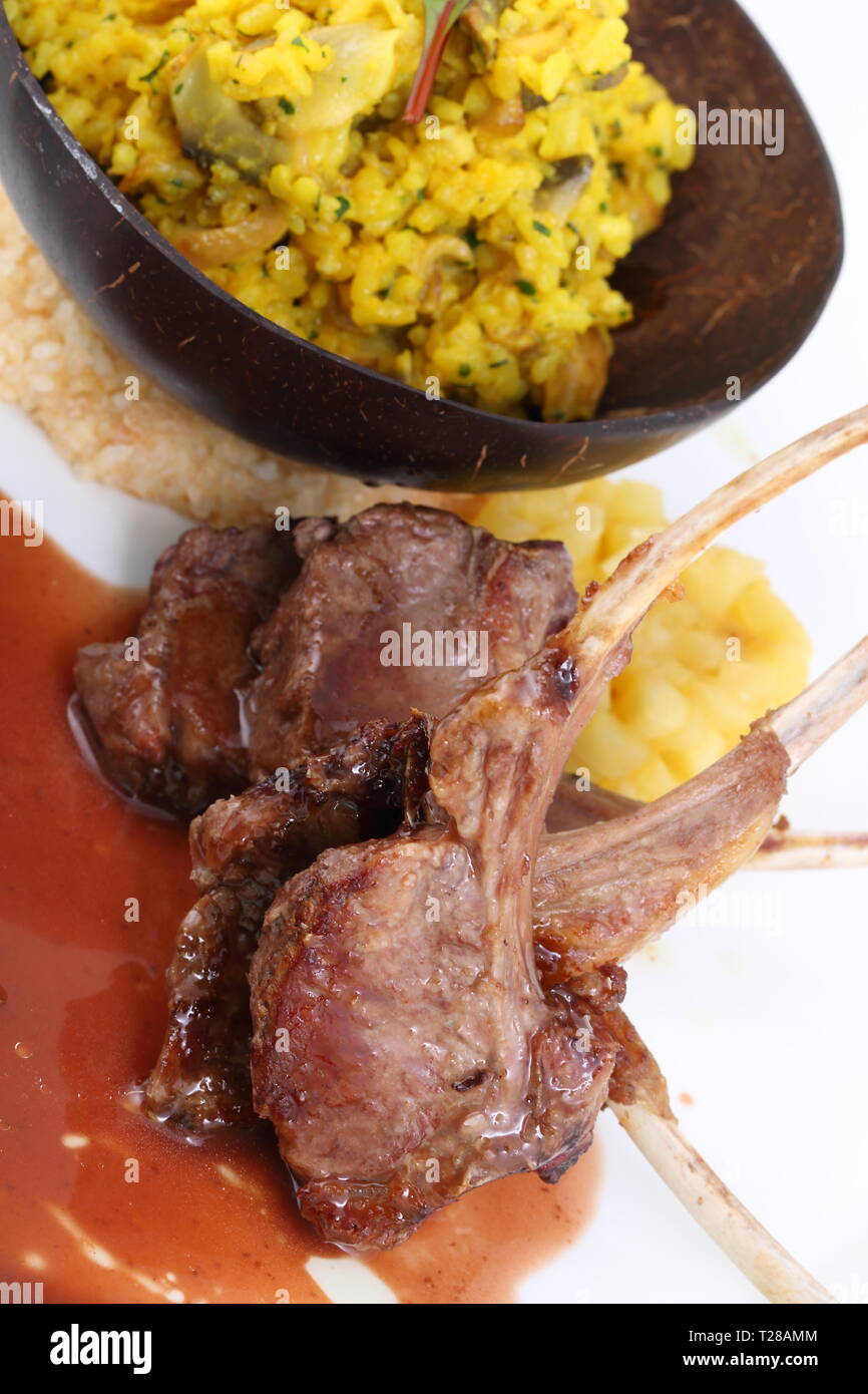 Rack of lamb with rice on a white background Stock Photo - Alamy