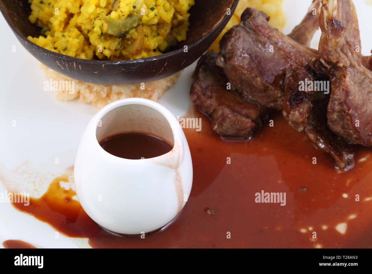 Rack of lamb with rice on a white background Stock Photo - Alamy